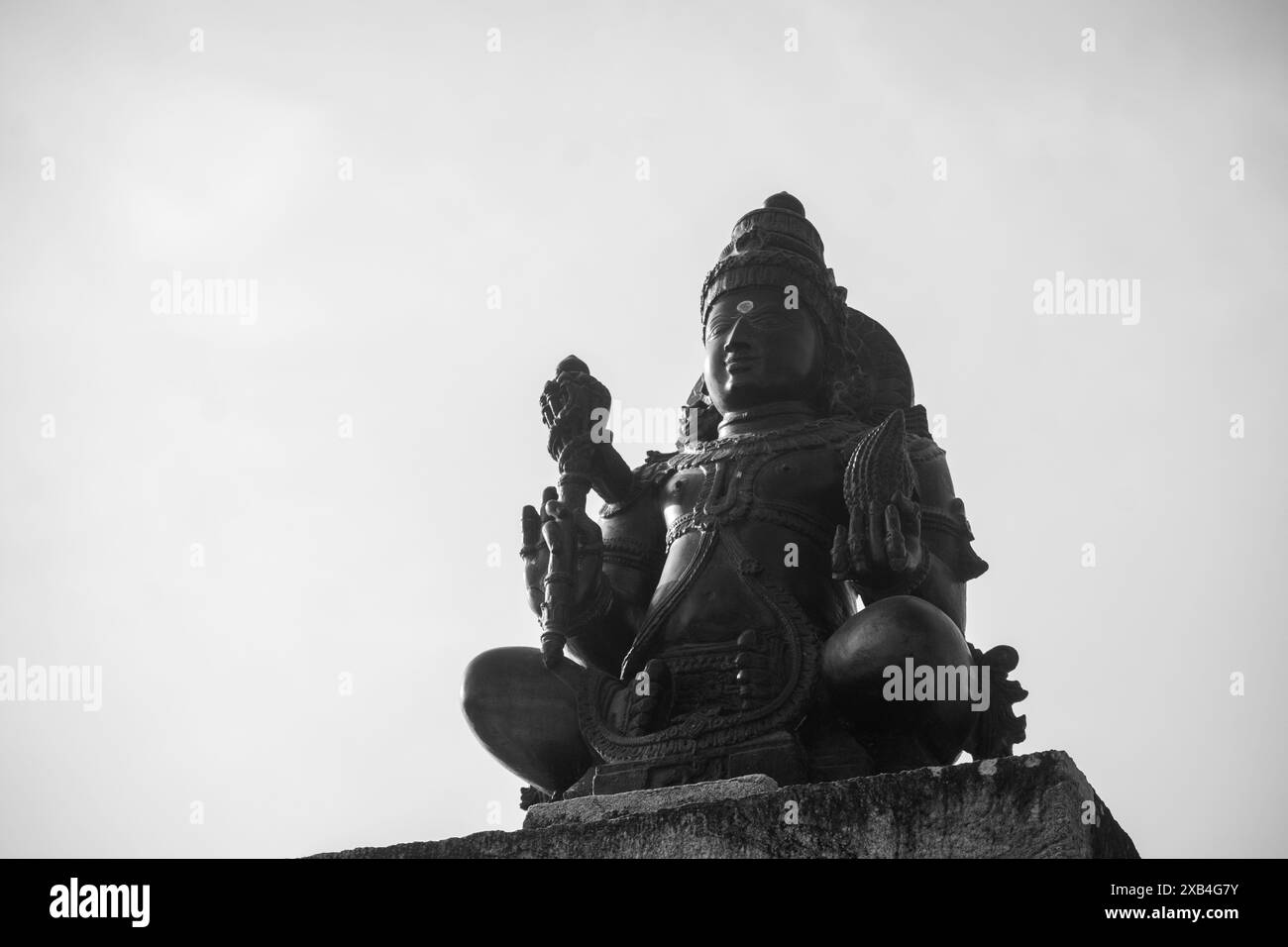 A close-up black and white photo of an ancient statue with a single eye ...