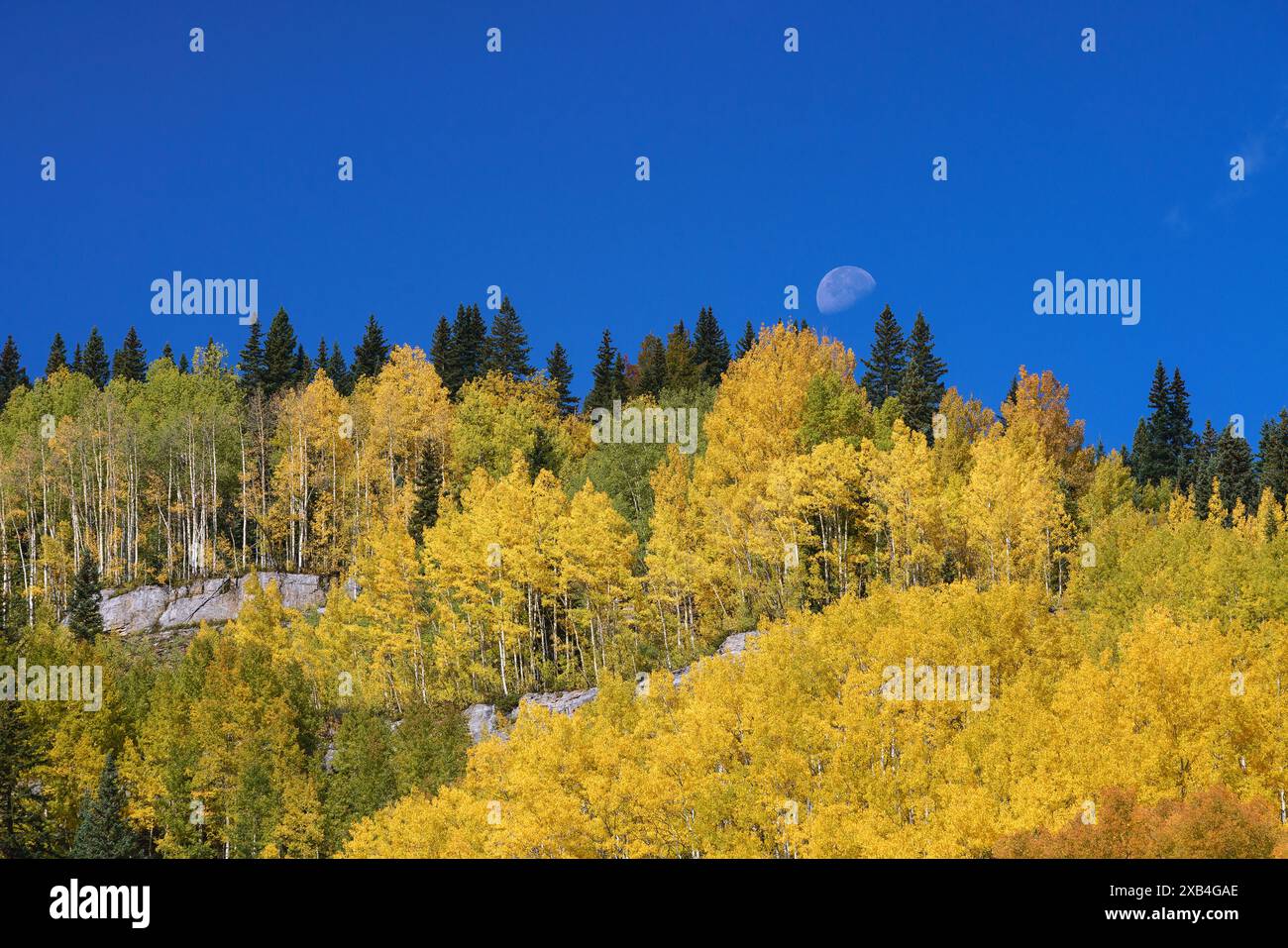 Moon sets over a colorful ridge line along the Million Dollar Highway ...