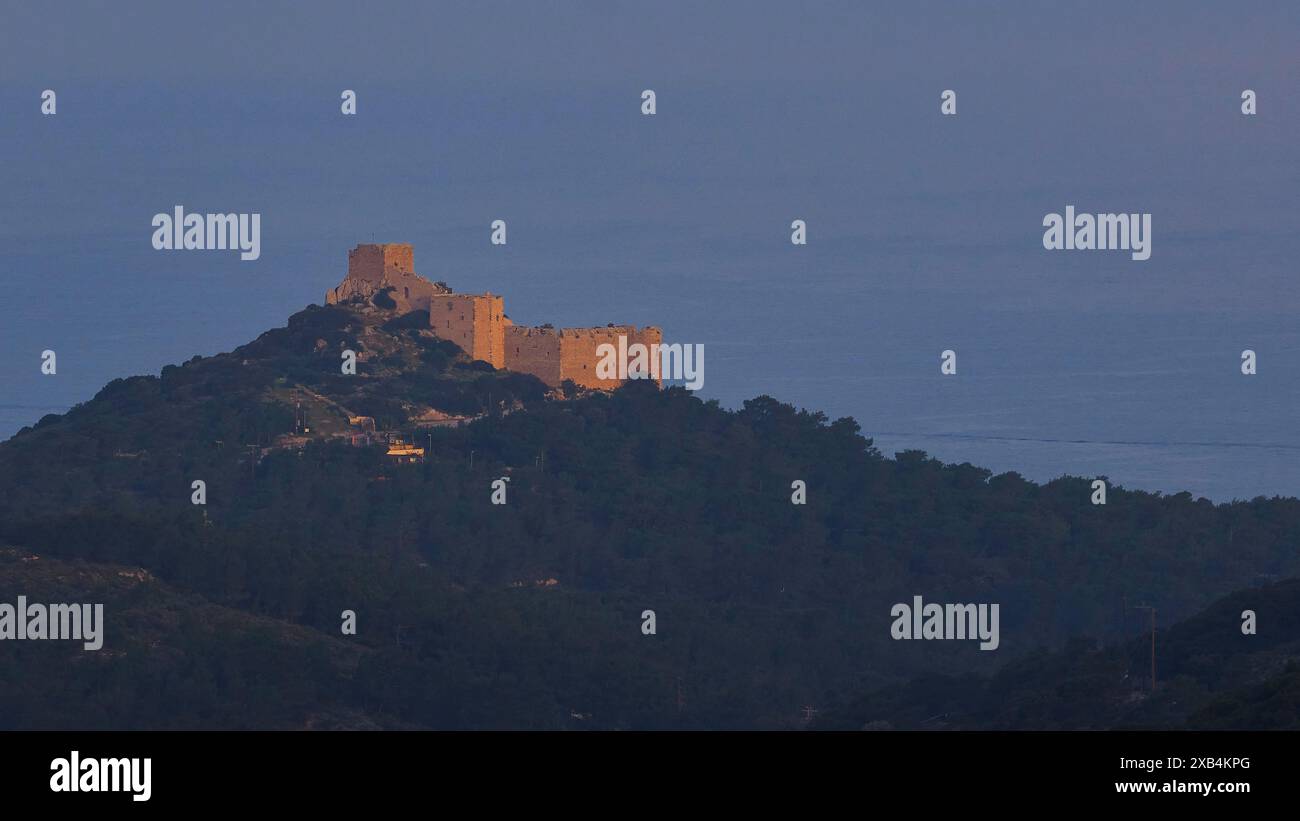 A castle on a hill in the first morning light, surrounded by natural ...