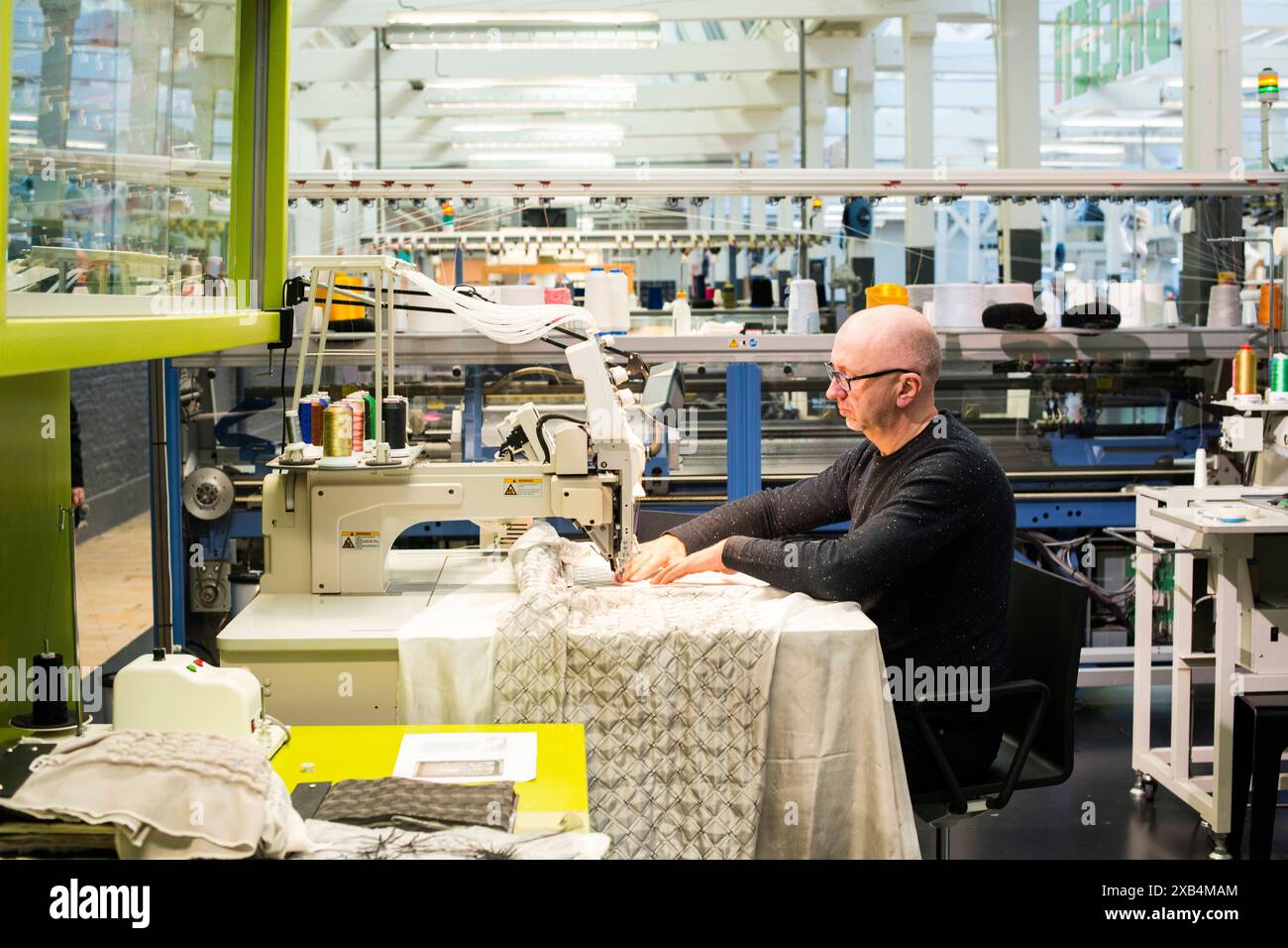 Man on Industrial Sewing Machine Middle aged caucasian male wearing ...