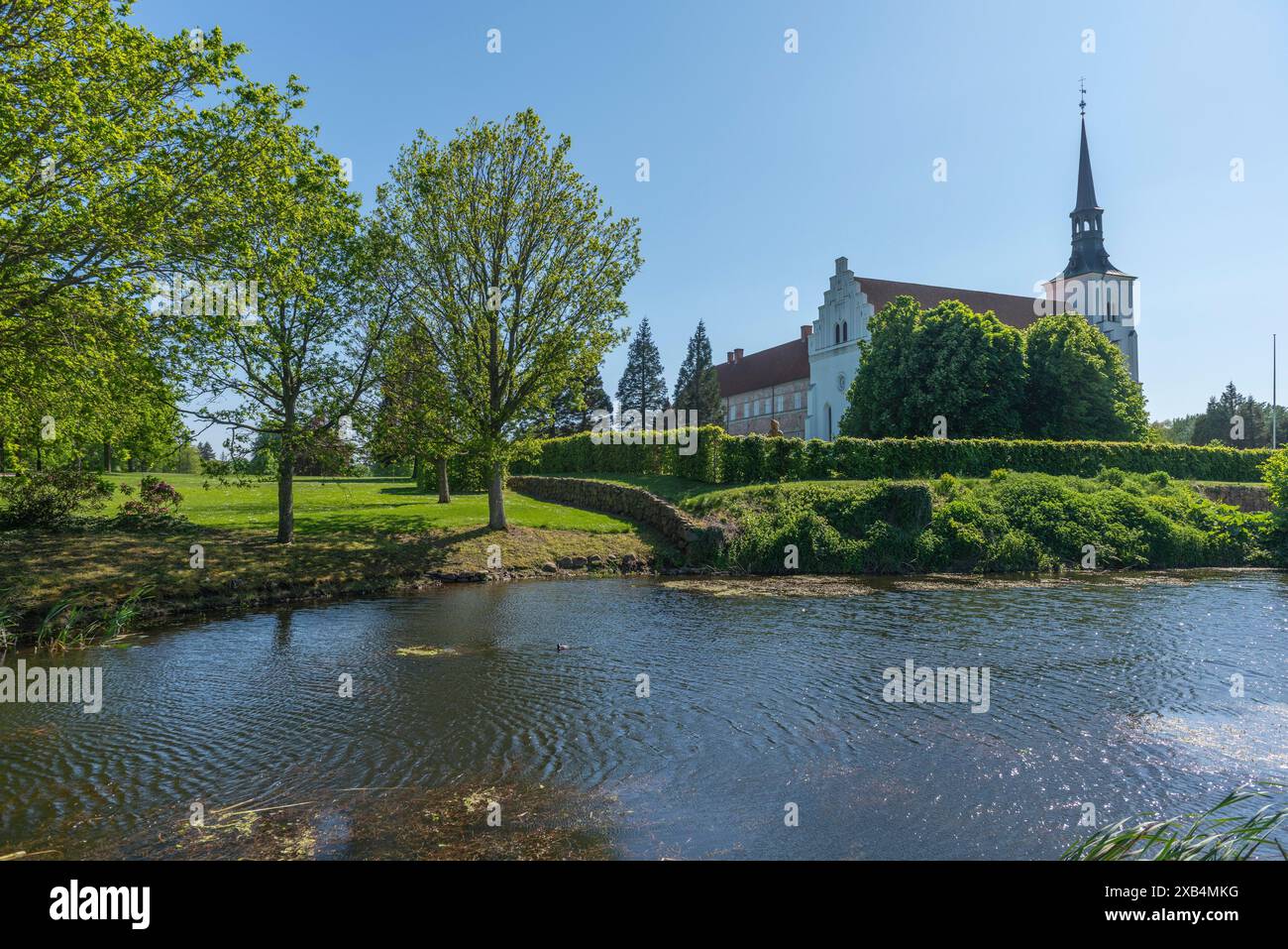 Brahetrolleborg church and castle, trees, Faborg, Faaborg, pond, Fyn ...
