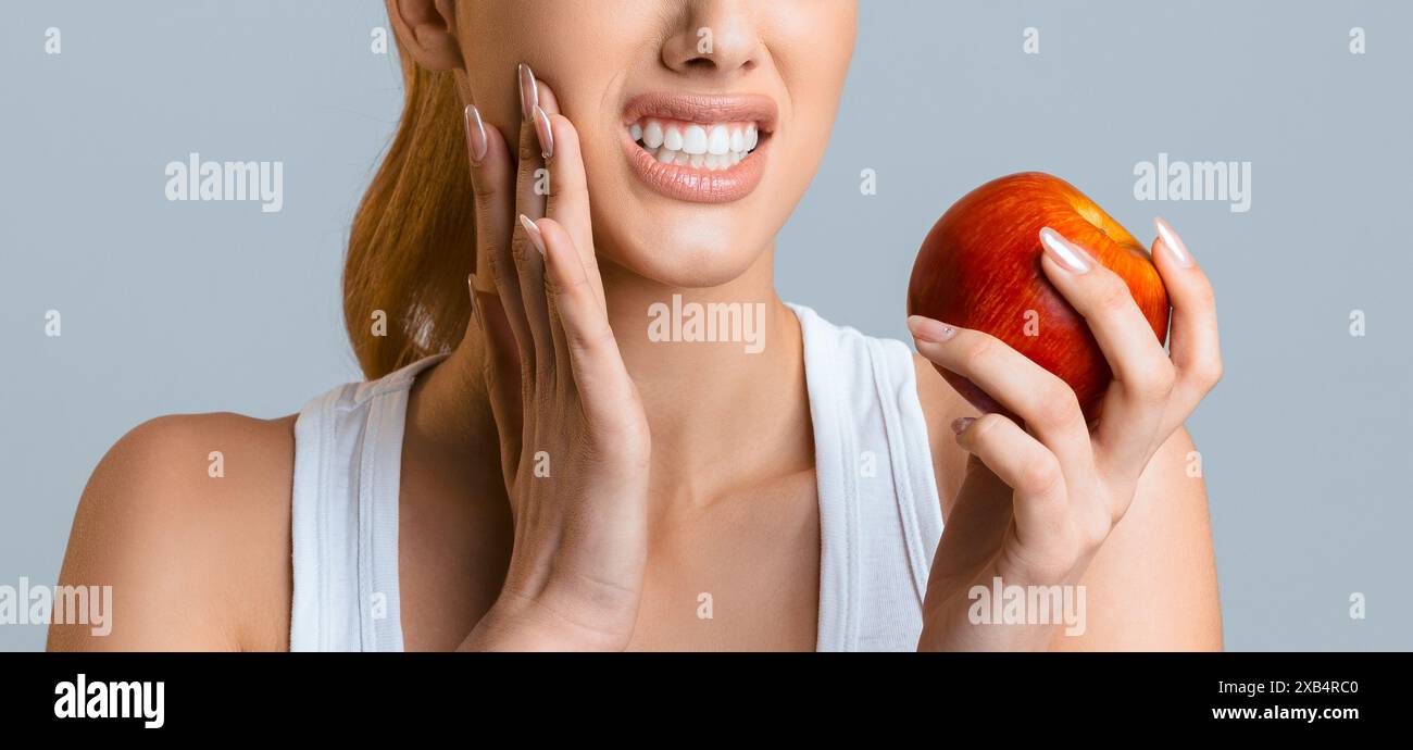 Tooth problems. Young woman having toothache, biting apple Stock Photo ...