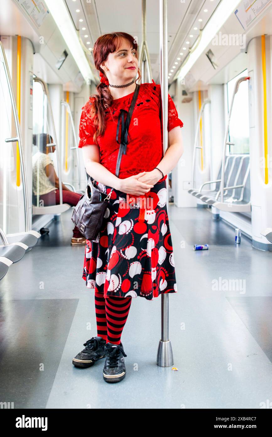 Young Woman Riding the Subway Young, redhaired woman riding an elevated ...