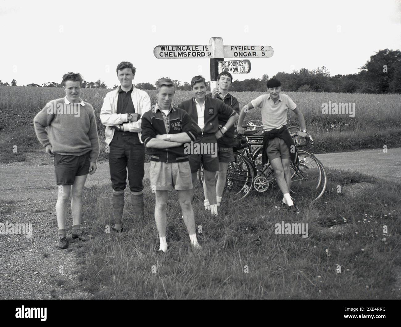 1960s, historical, young touring cyclists by road sign, England, UK ...
