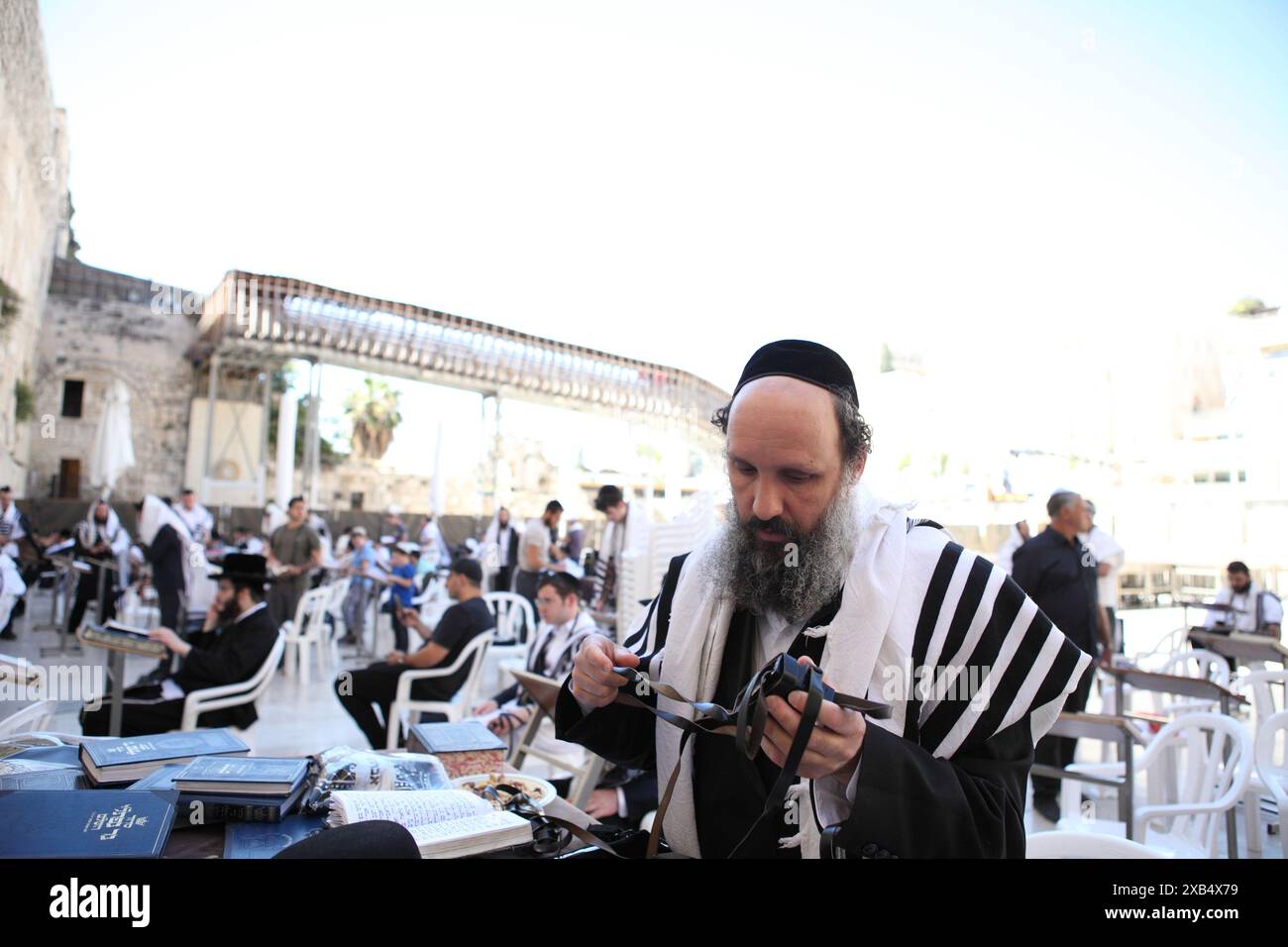 Ultra Orthodox Jew wearing a Talith, folds his Tefillin at end of ...
