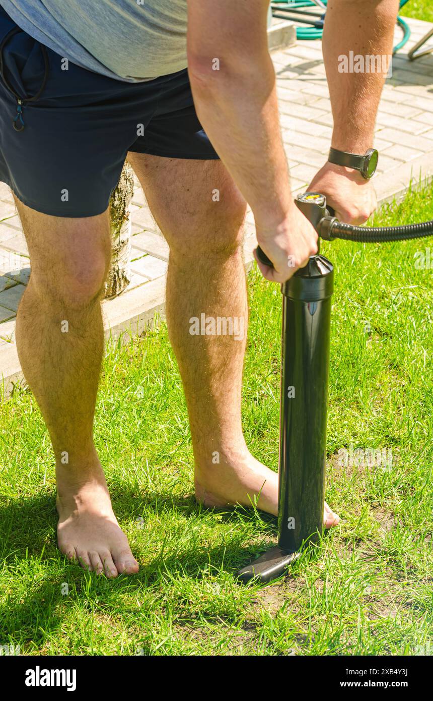 Man pumping air into the wheel.Pumping air into an empty wheel of bike ...