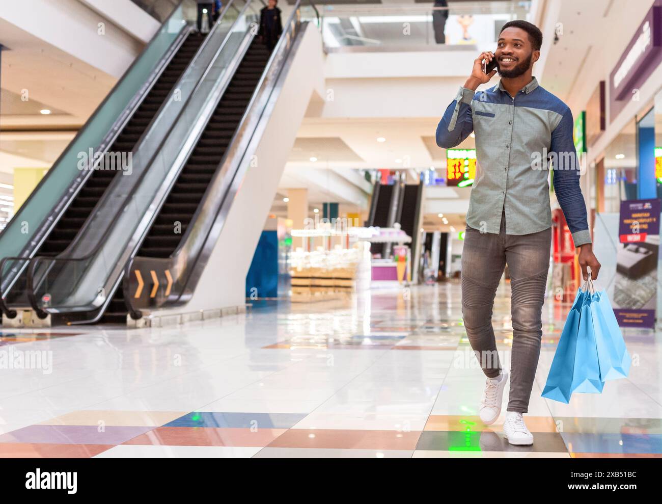 Man walking through shopping mall hi-res stock photography and images ...
