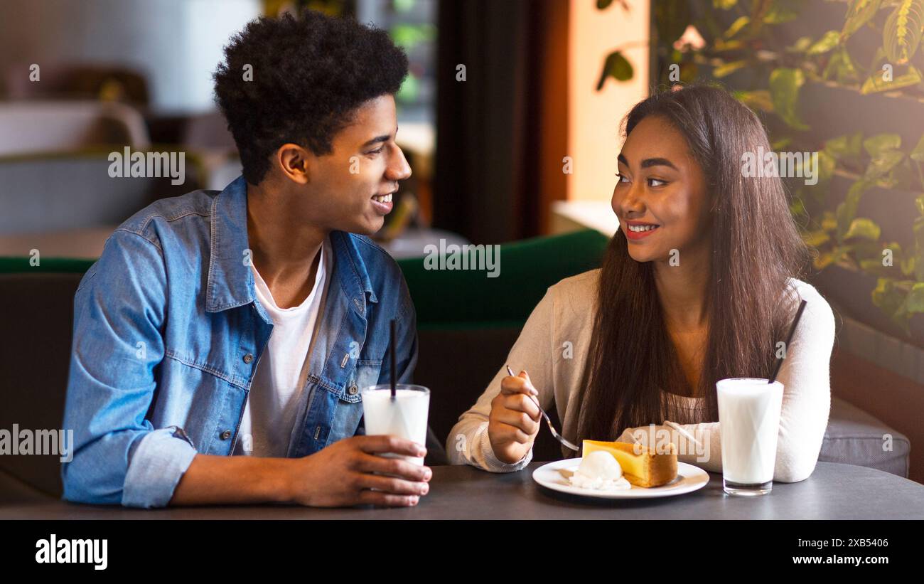 Guy girl sitting wooden table hi-res stock photography and images - Alamy