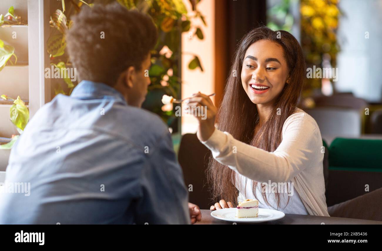 Guy Giving Girl Piece of Cake in Restaurant Stock Photo - Alamy