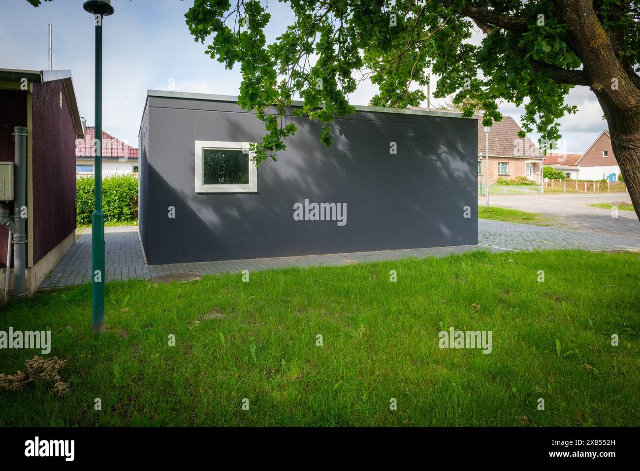 Anewly built double garage with roller doors stands under a tree Stock ...