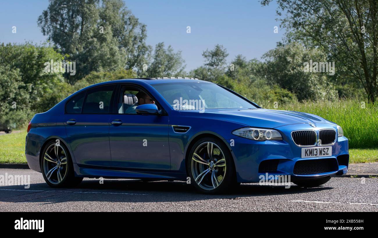 Stony Stratford,UK - June 2nd 2024: 2013 blue BMW M5 car driving on a ...