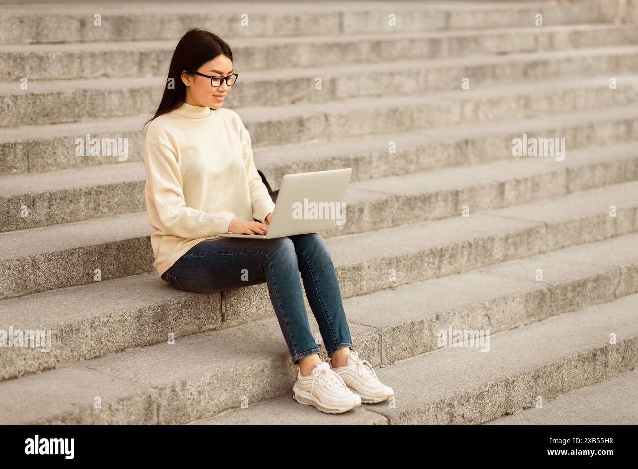 Woman Sitting on Steps Using Laptop Computer, Doing Homework Stock ...
