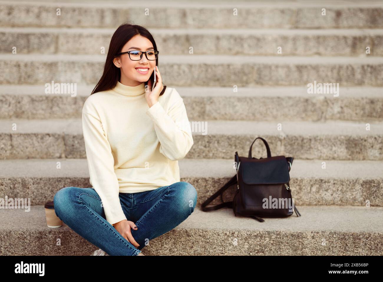 Attractive Korean Woman Sitting on Steps Talking on Cell Phone Stock ...