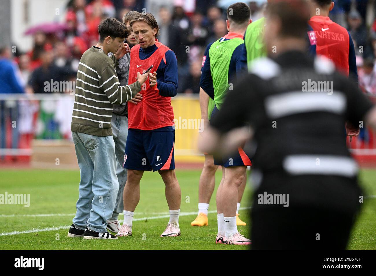 Luka Modric of Croatia is pictured as he hugs a fan who run into pitch ...