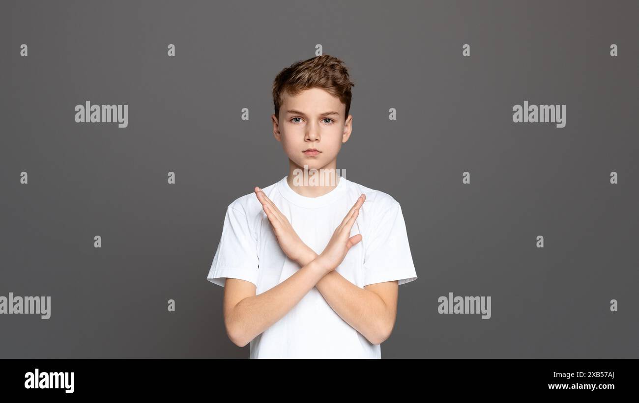 Youngster with arms crossed making stop sign Stock Photo - Alamy