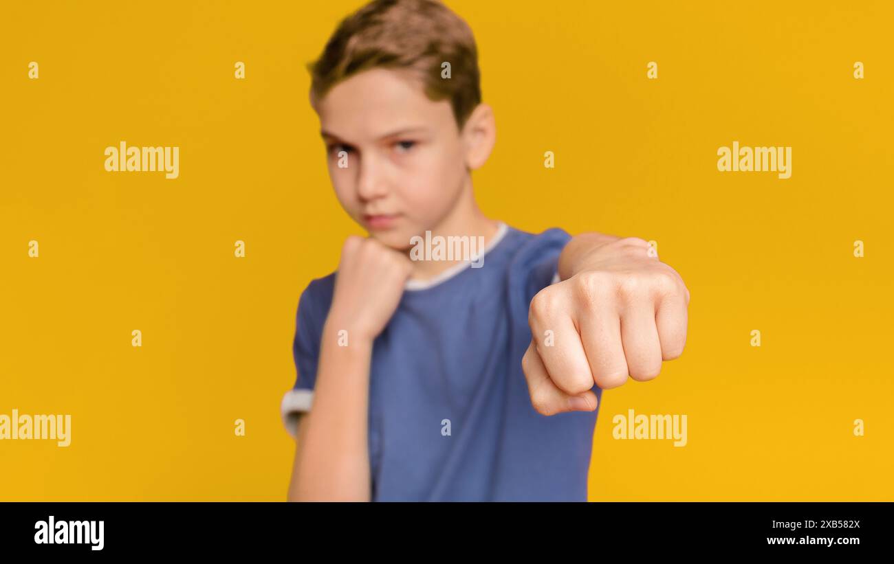 Serious teen boy training box punch, focus on fist Stock Photo - Alamy