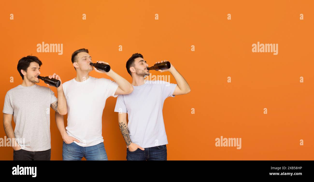 Friends drinking soda together on orange, copy space Stock Photo - Alamy