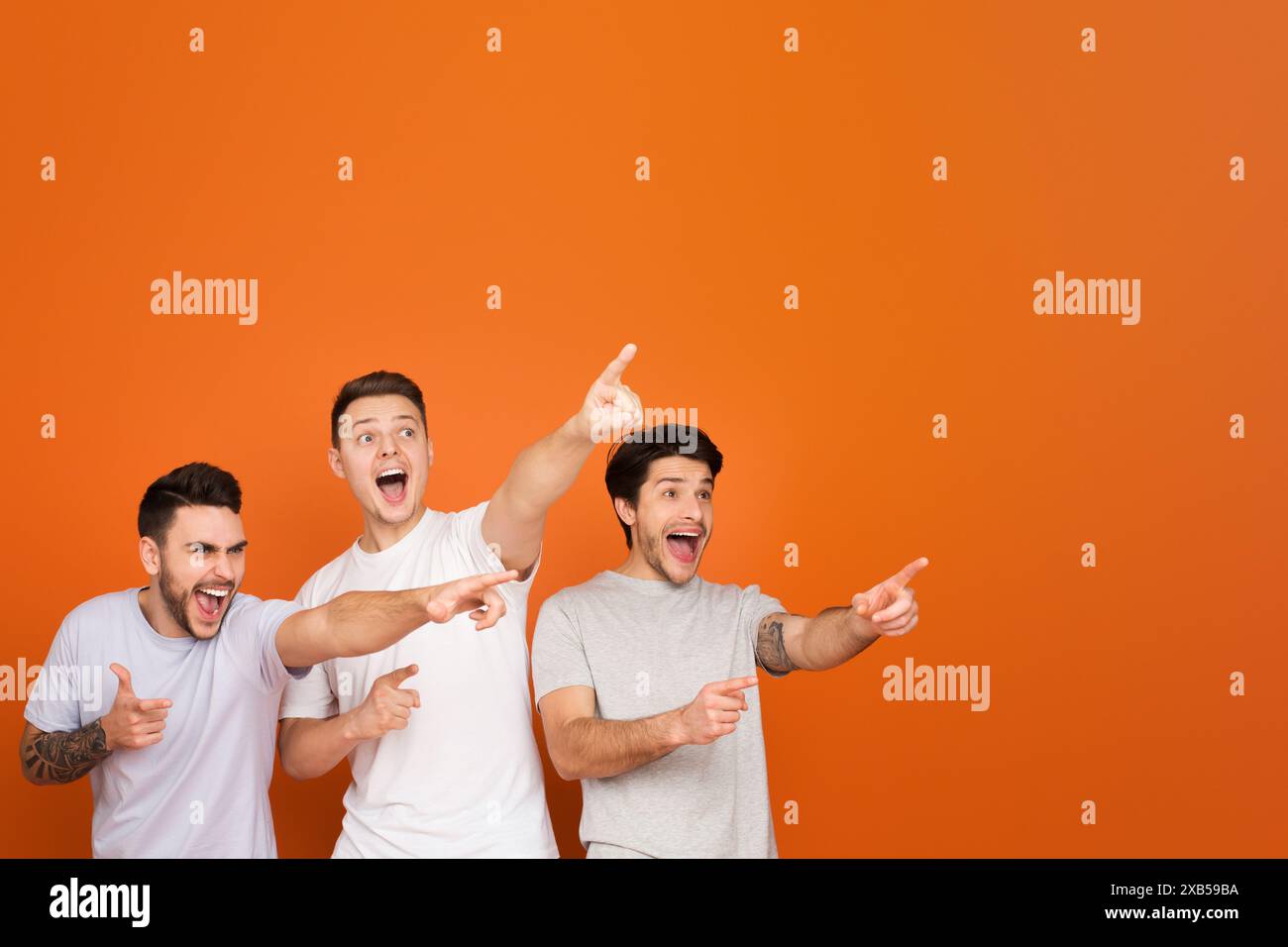 Three men pointing and laughing together, copy space Stock Photo - Alamy