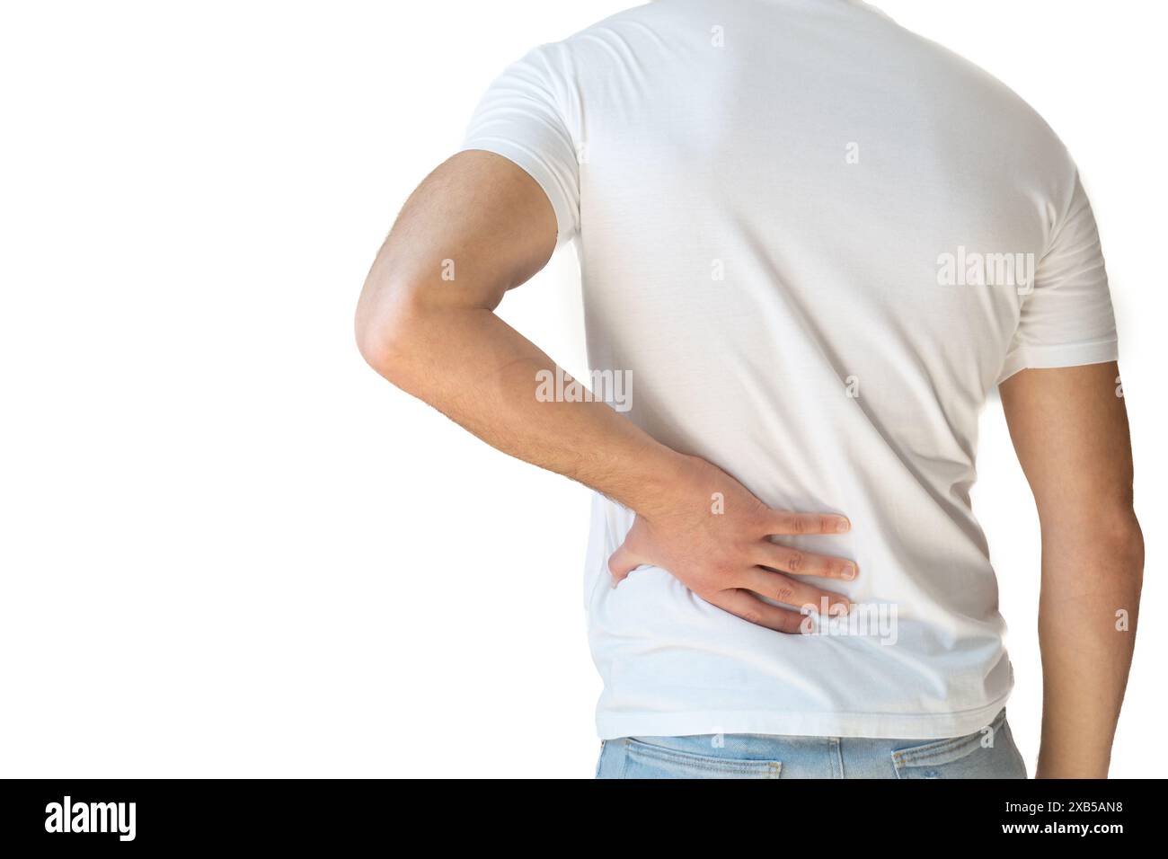 Rear view of a handsome attractive young man holding his back in pain ...