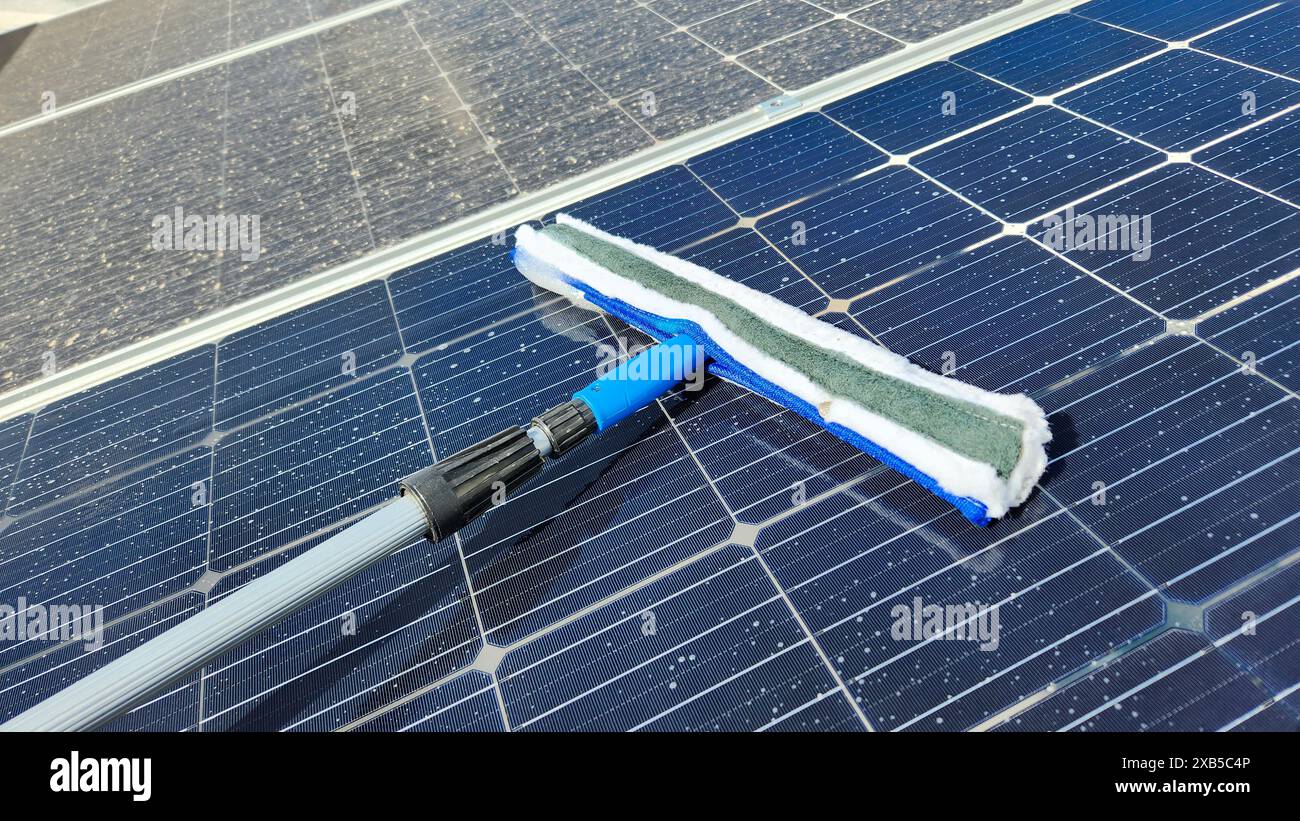 Cleaning dirty solar panels. Maintenance Stock Photo - Alamy