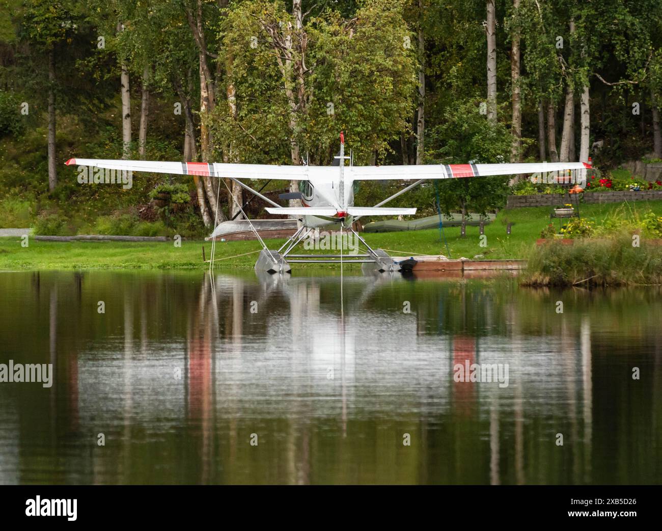 A plane is sitting on floats in the water and it has a very clear ...