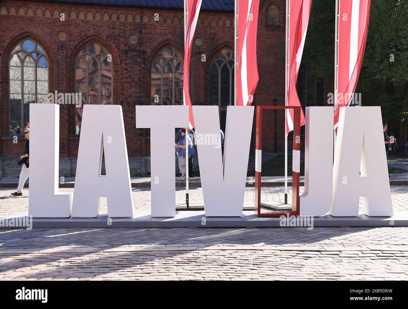 Latvia sign for tourists to be photographed by on cobbled Dome Square ...