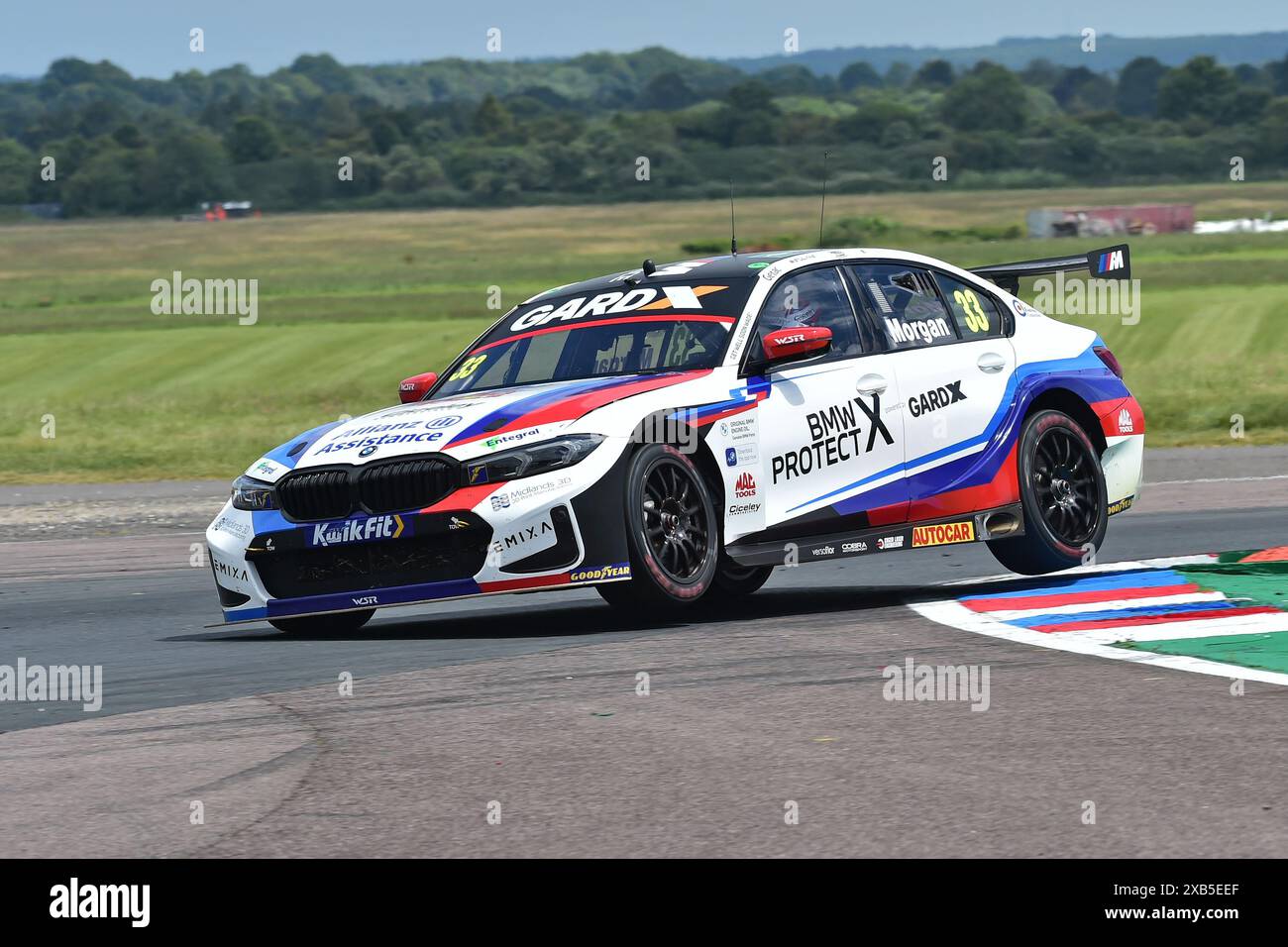 Adam Morgan, BMW 330e M Sport, Team BMW, on three wheels at the chicane ...
