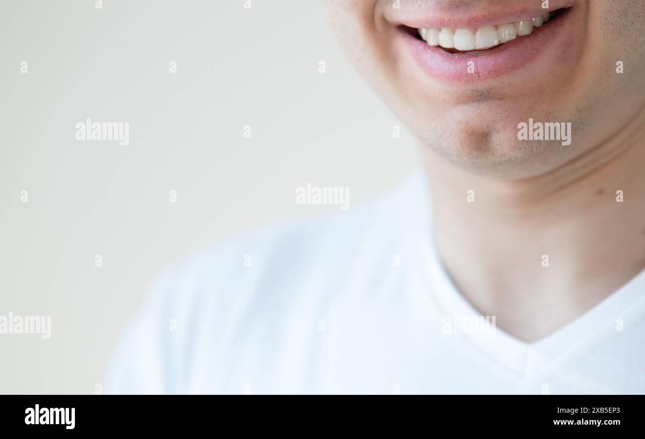 smiling young man with white straight teeth wearing transparent dental ...