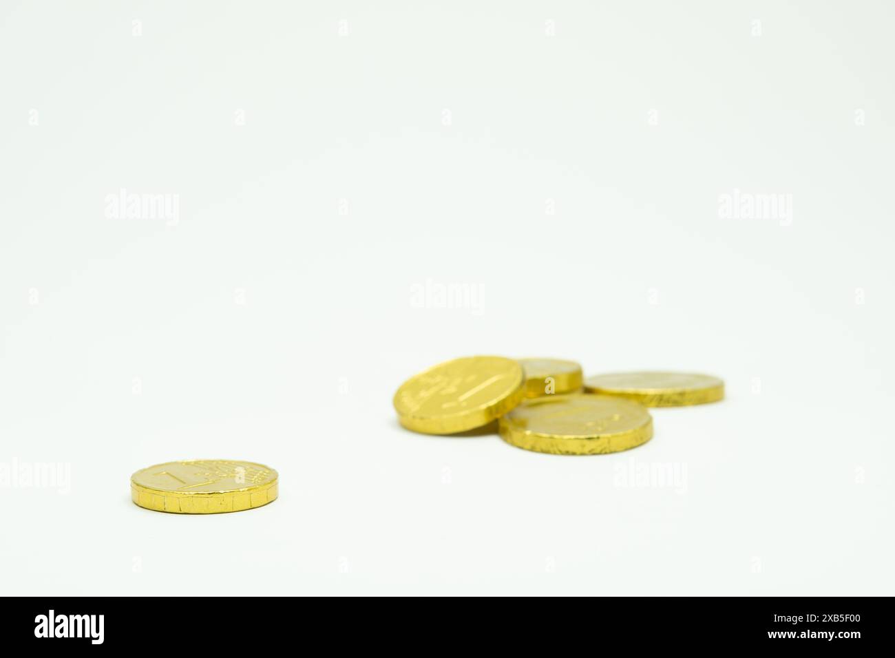 Pile of gold chocolate coins isolated on white background, stack of ...