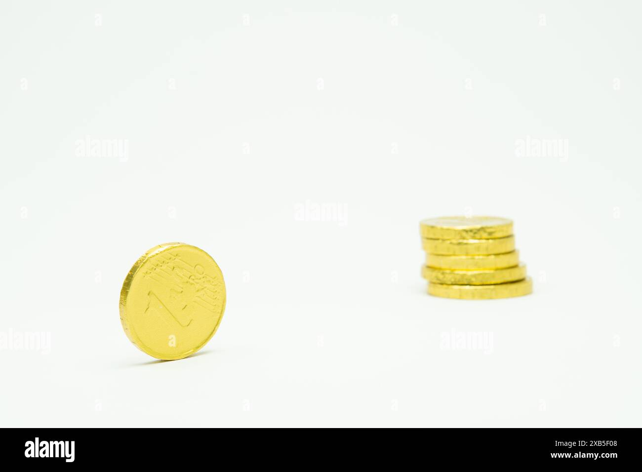 Pile of gold chocolate coins isolated on white background, stack of ...