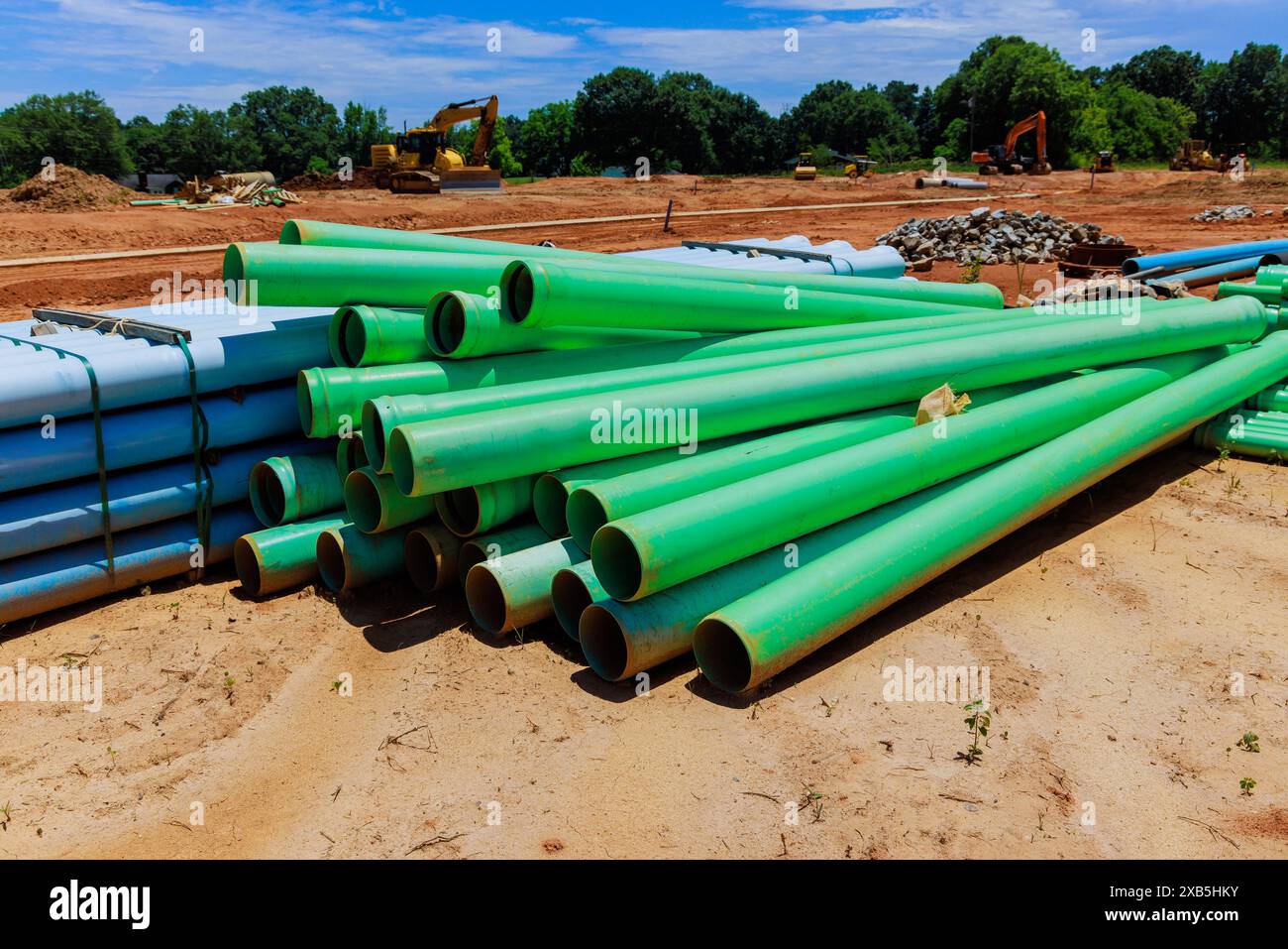 Green PVC pipes are being used on construction sites for laying water ...