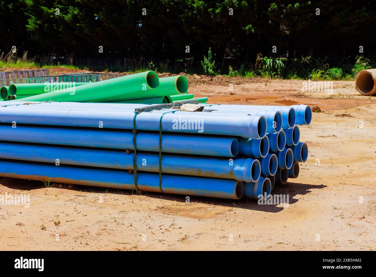 On construction site there are blue PVC pipes for laying pipe water ...