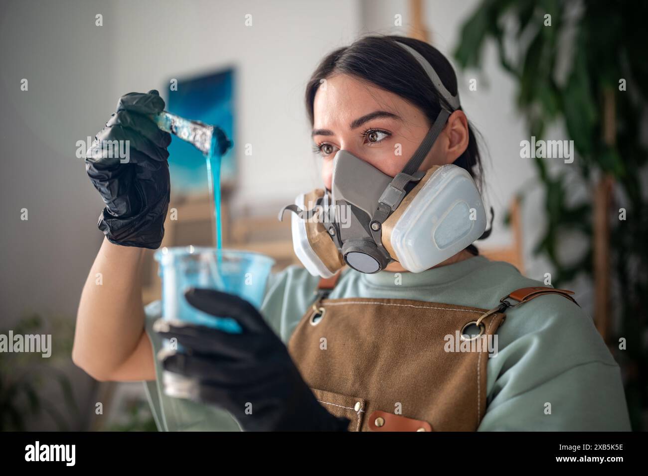 Focused on consistency artist in respirator and latex gloves testing ...