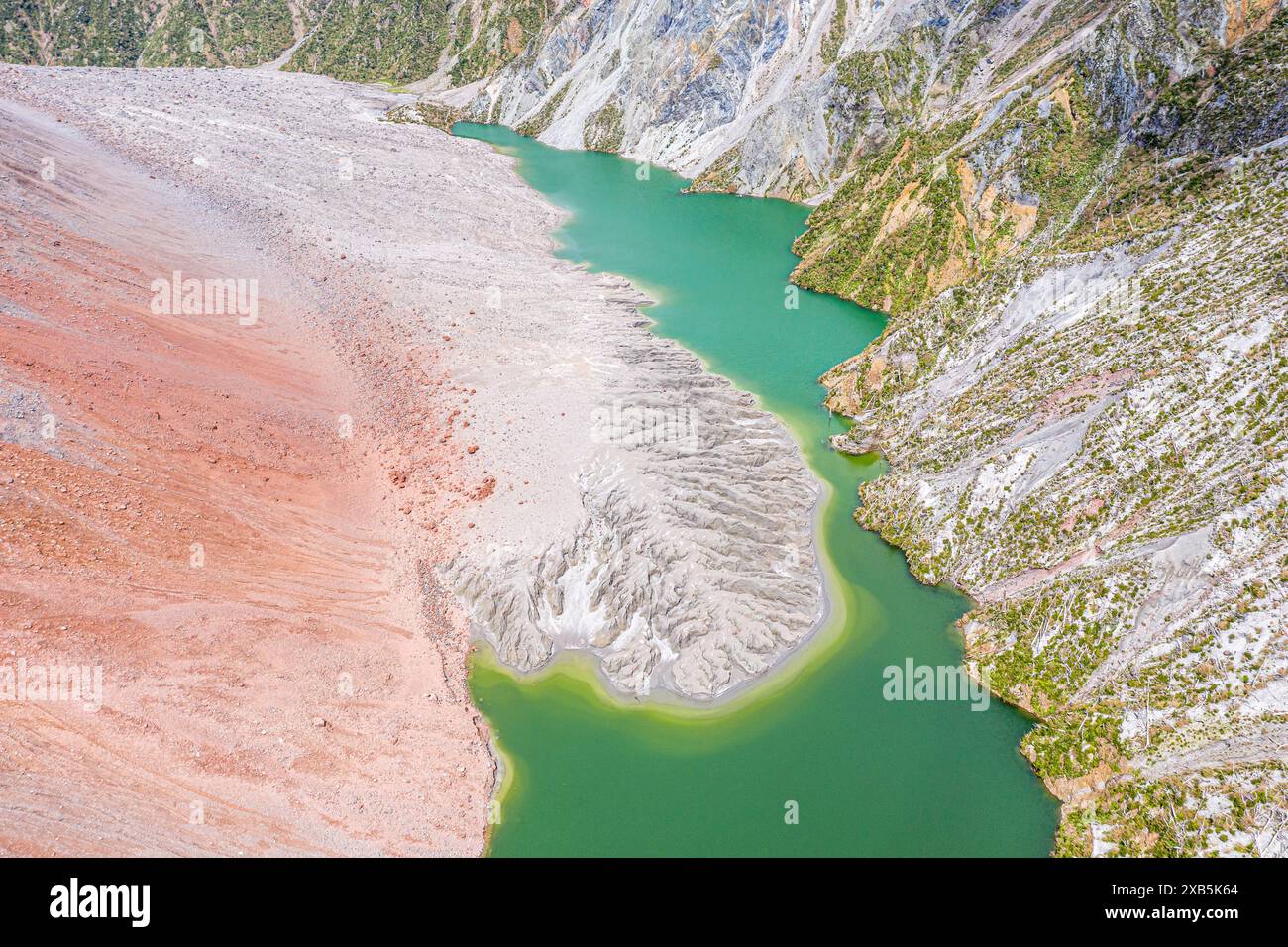 Lake with sandbank and dead trees, crater rim of chaiten volcano ...