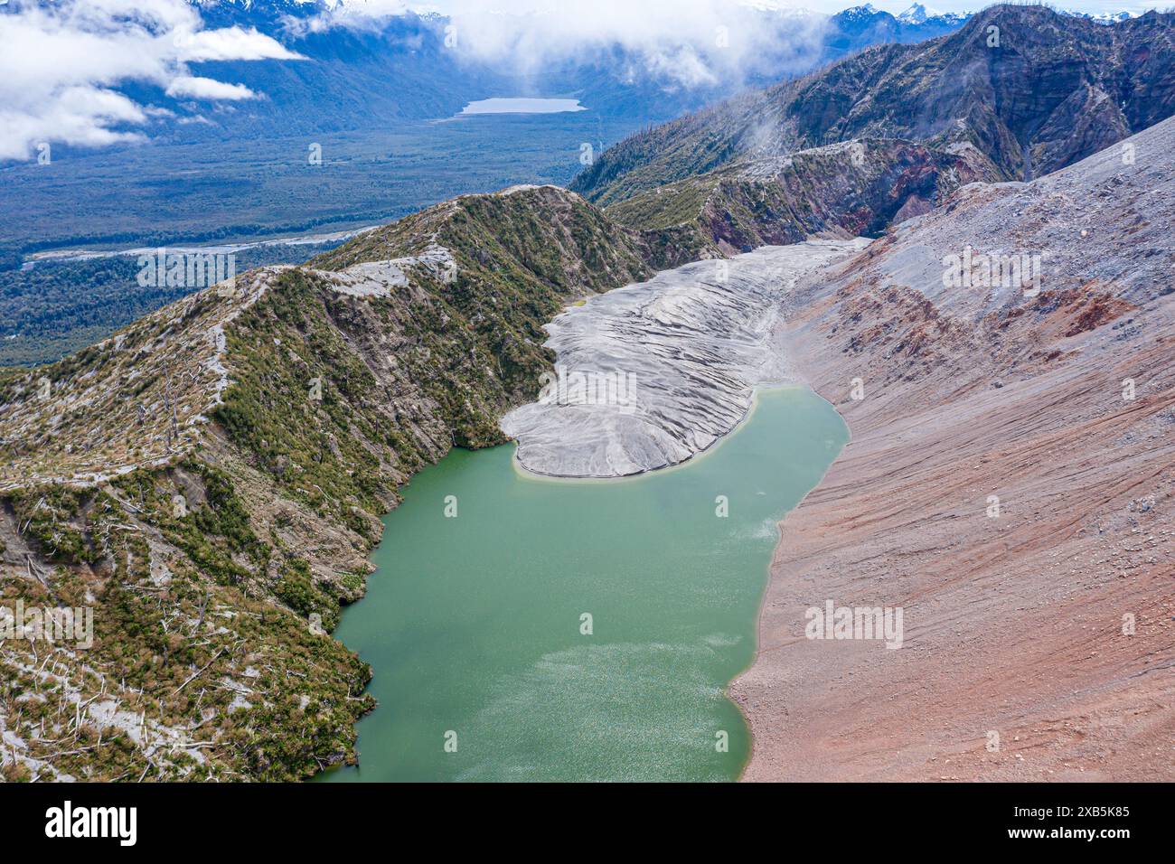 Lake with sandbank and dead trees, crater rim of chaiten volcano ...