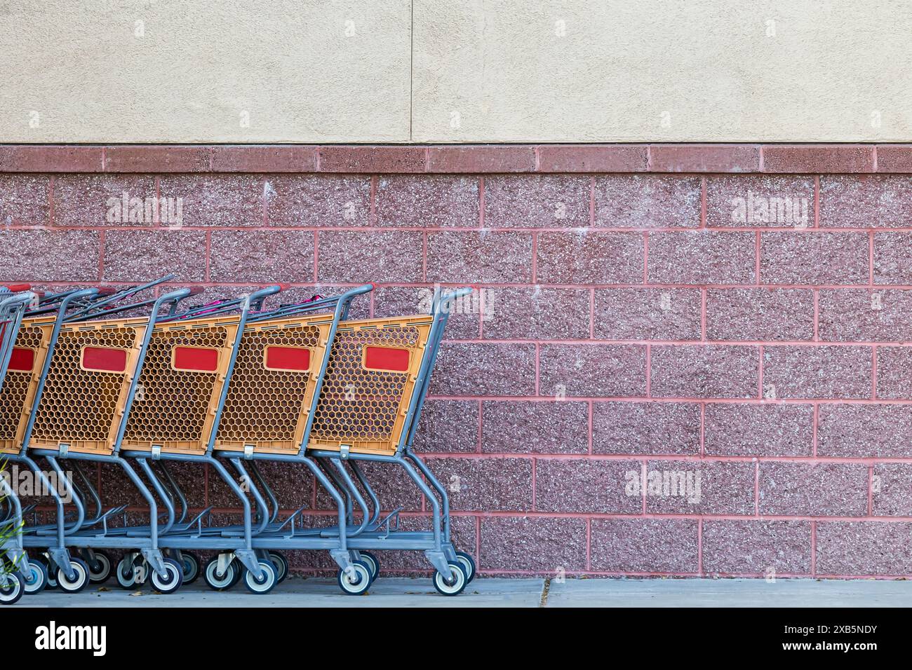 Stacked shopping carts near the wall Stock Photo - Alamy