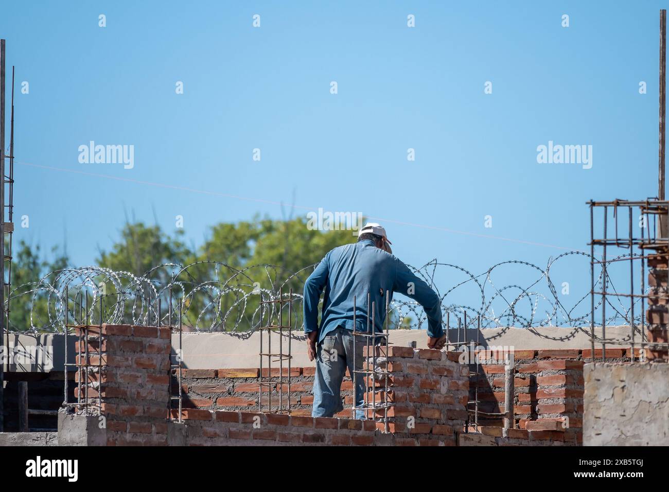 Bricklayer laying mud bricks in house construction in Argentina Stock ...