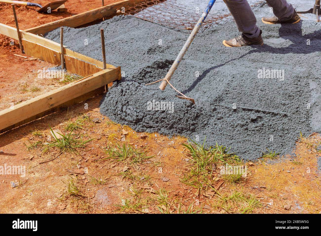 To pour concrete into foundation of house, ground is leveled filled ...