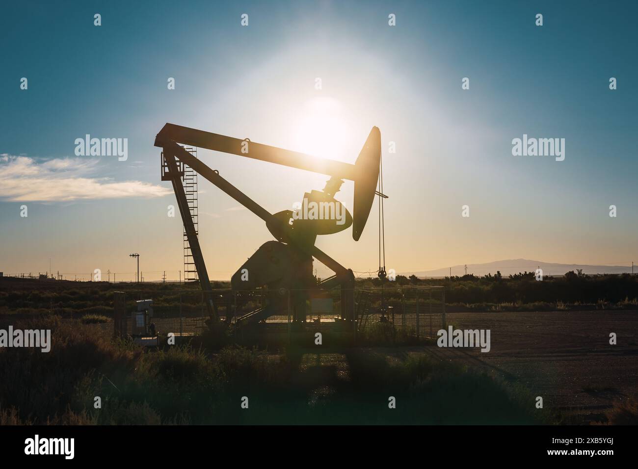 Oil pump and oil refining factory at sunset. Energy industrial concept ...