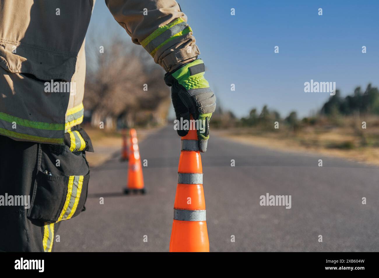 Firefighter putting cone on road Stock Photo - Alamy