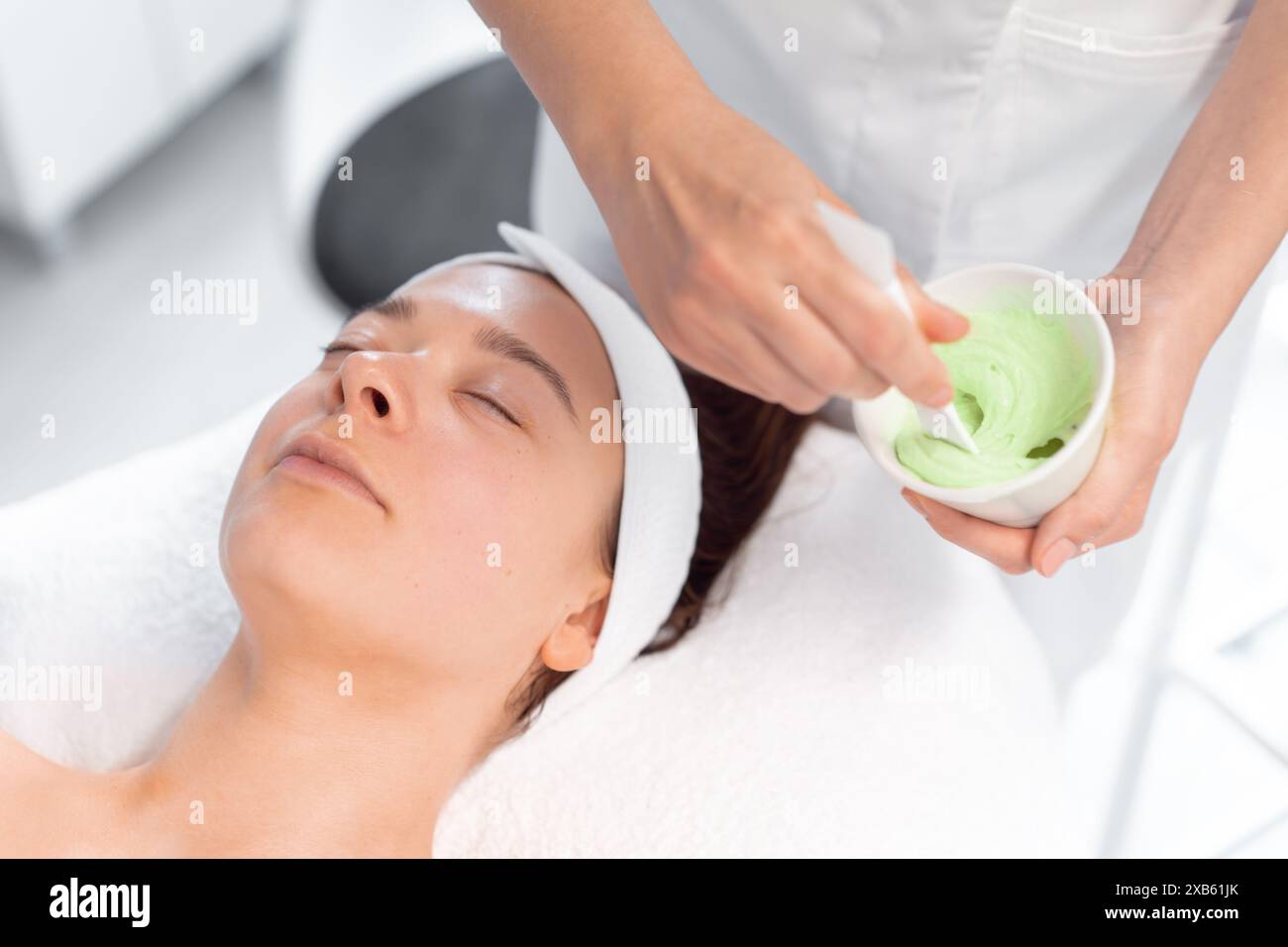 Cosmetologist mixing alginate mask in hi-res stock photography and ...