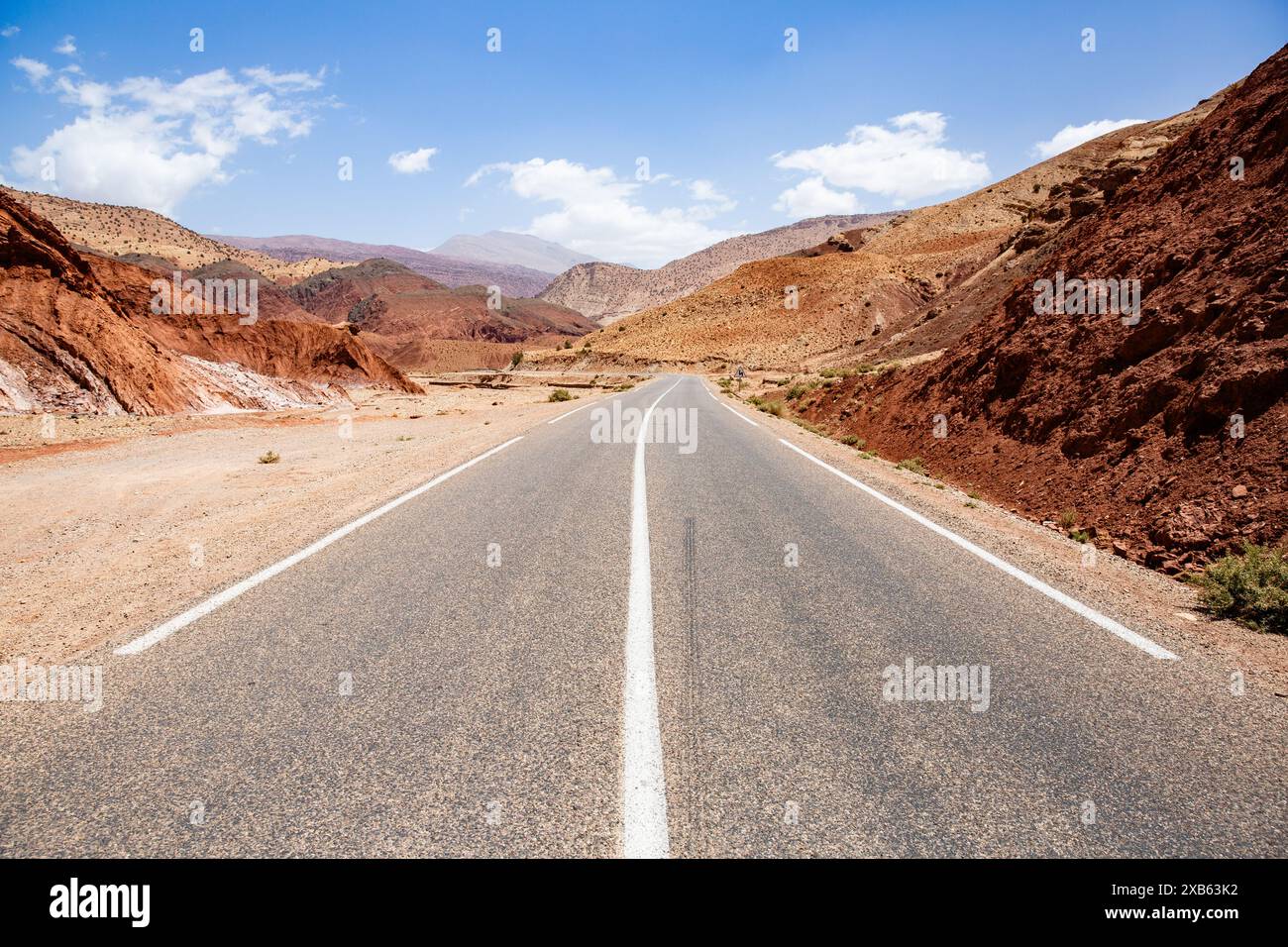 A road cutting through the brown and red desert landscape of eastern ...