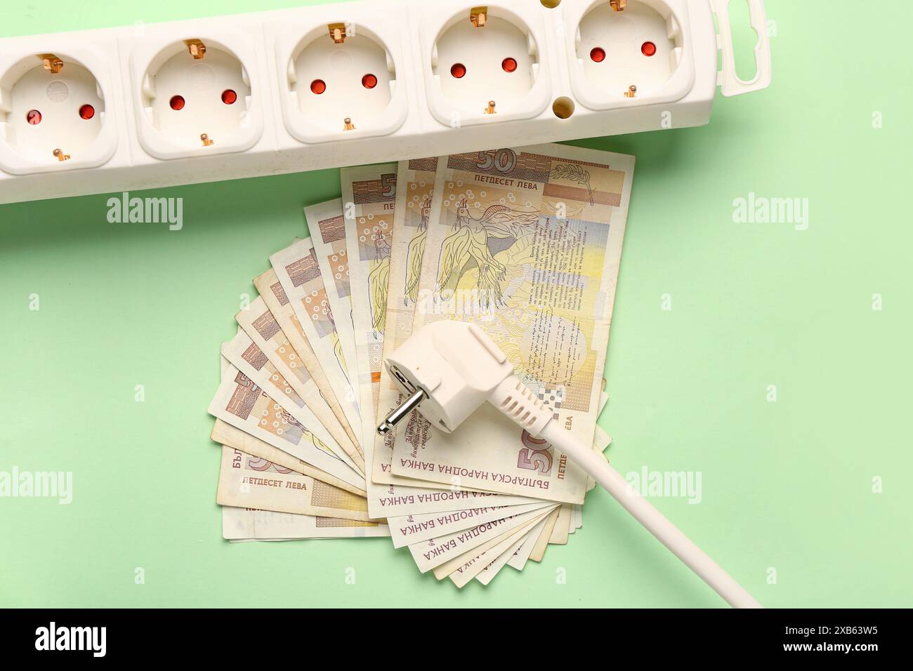 Bulgarian lev banknotes with plug and power socket on green background ...