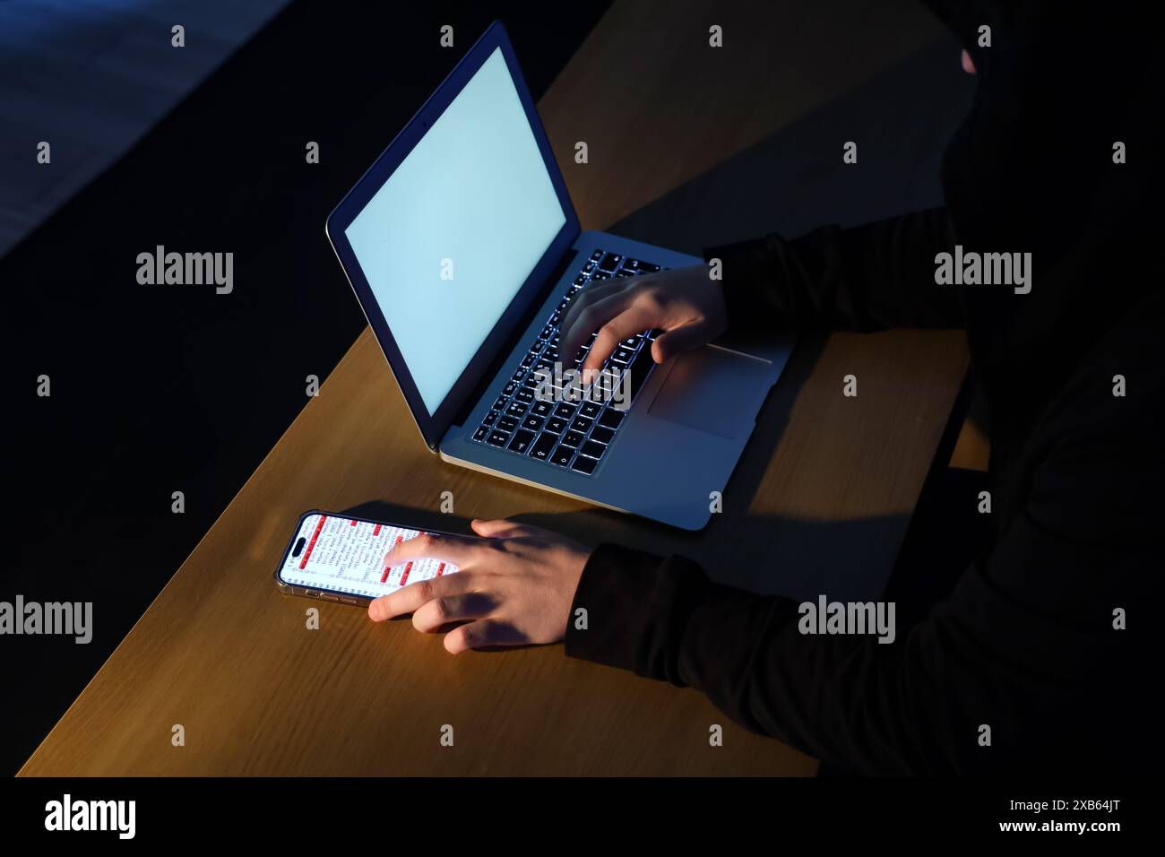Professional hacker using mobile hi-res stock photography and images ...
