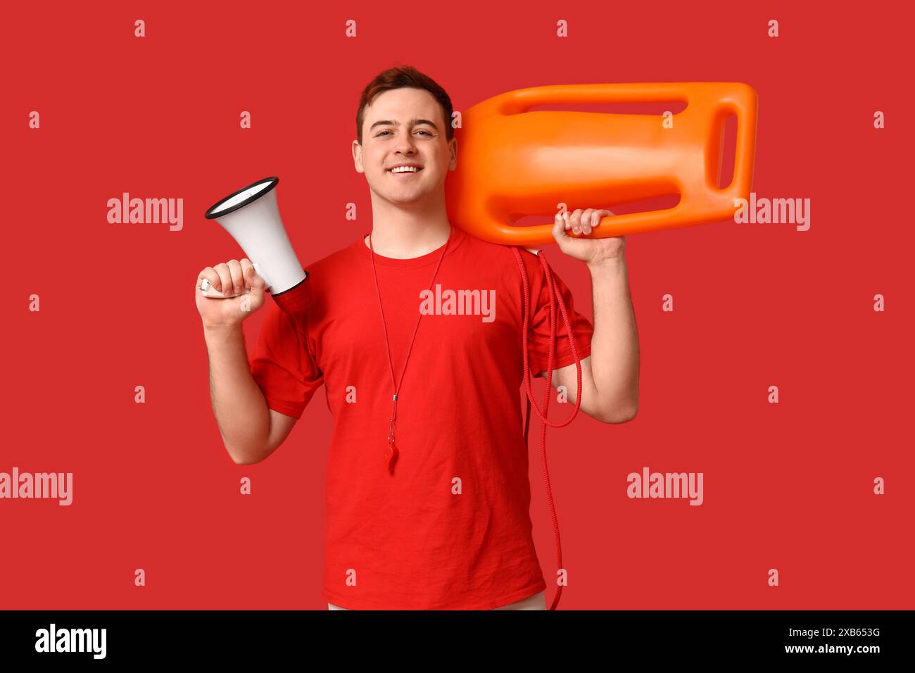 Male lifeguard with rescue tube buoy and megaphone on red background ...