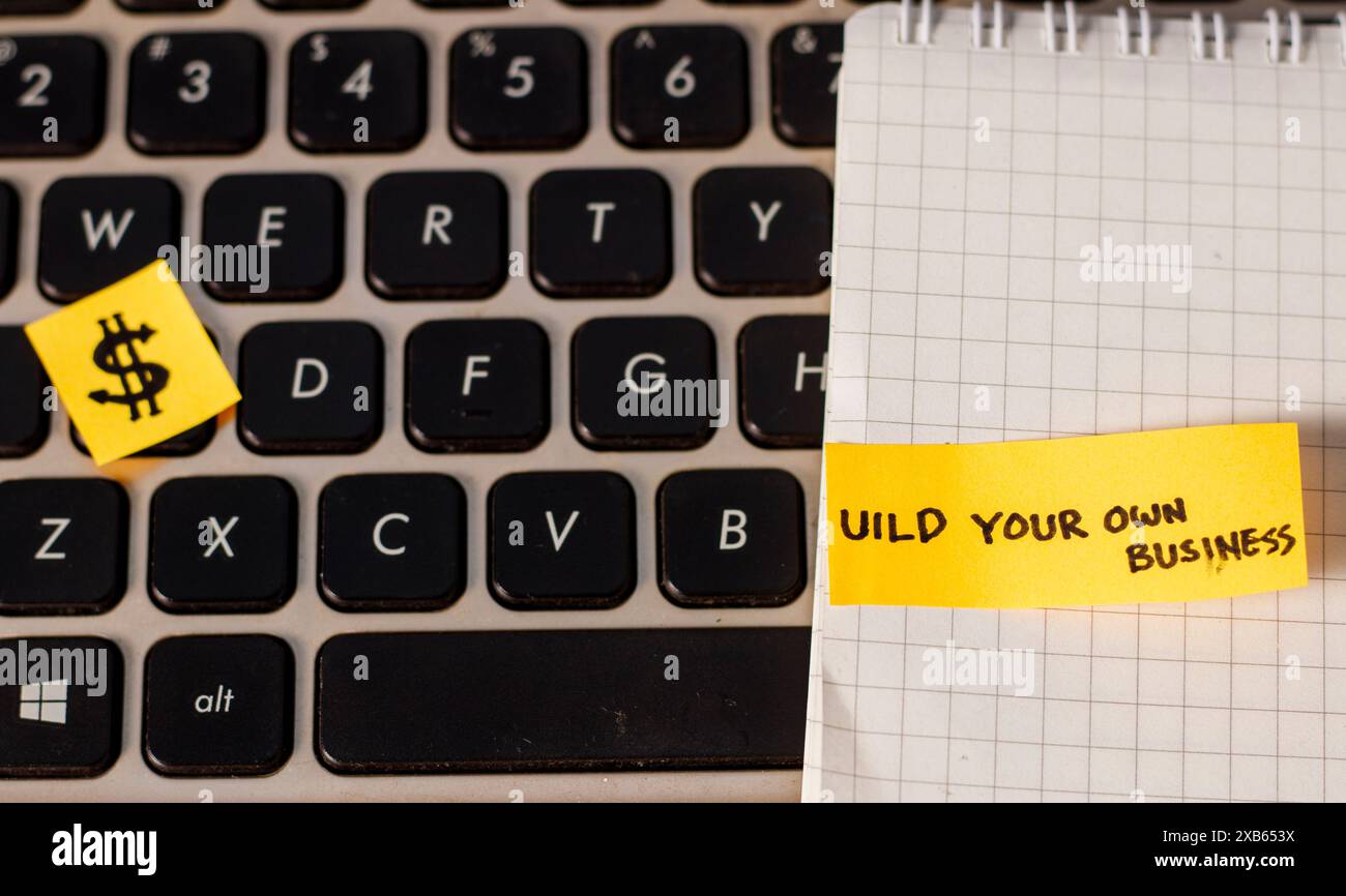 Laptop keyboard background with sticky notes with the dollar logo and ...