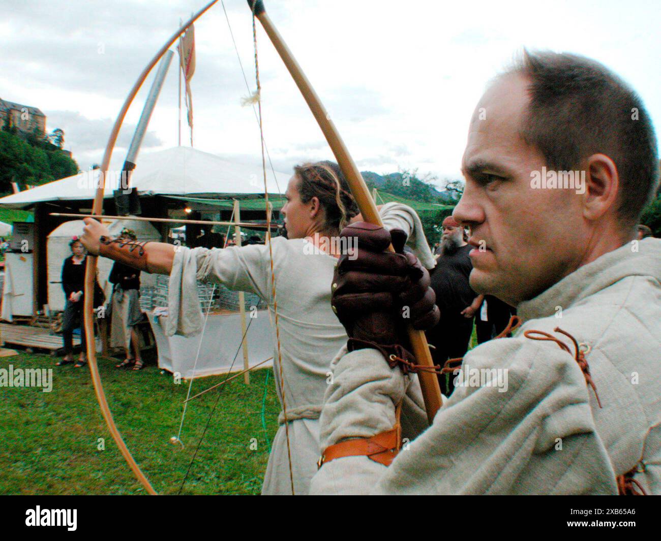 Archer with a bow and arrow aiming in the twilight Archer with bow and ...