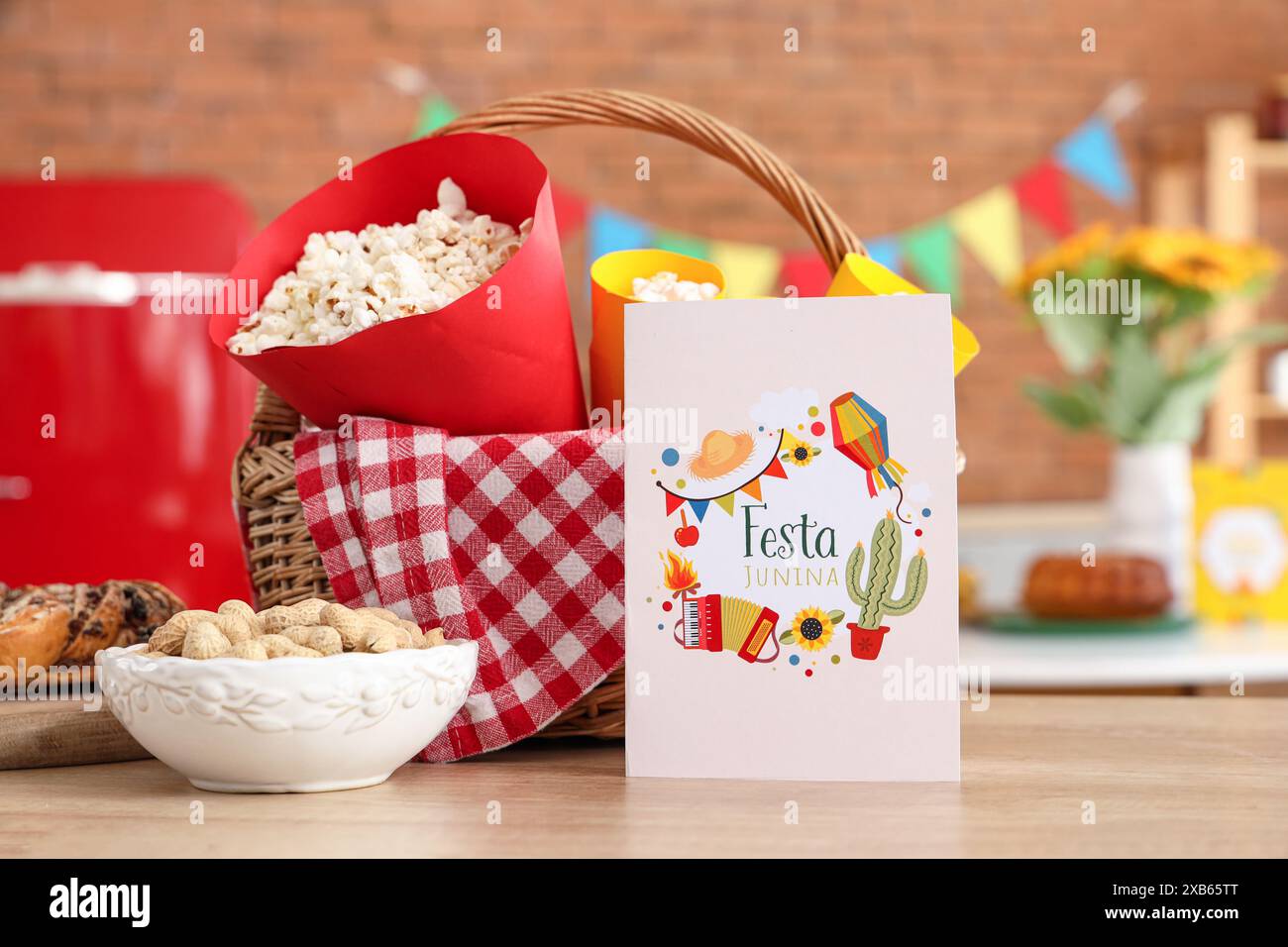 Wicket basket with popcorn, peanuts and greeting card on table in ...
