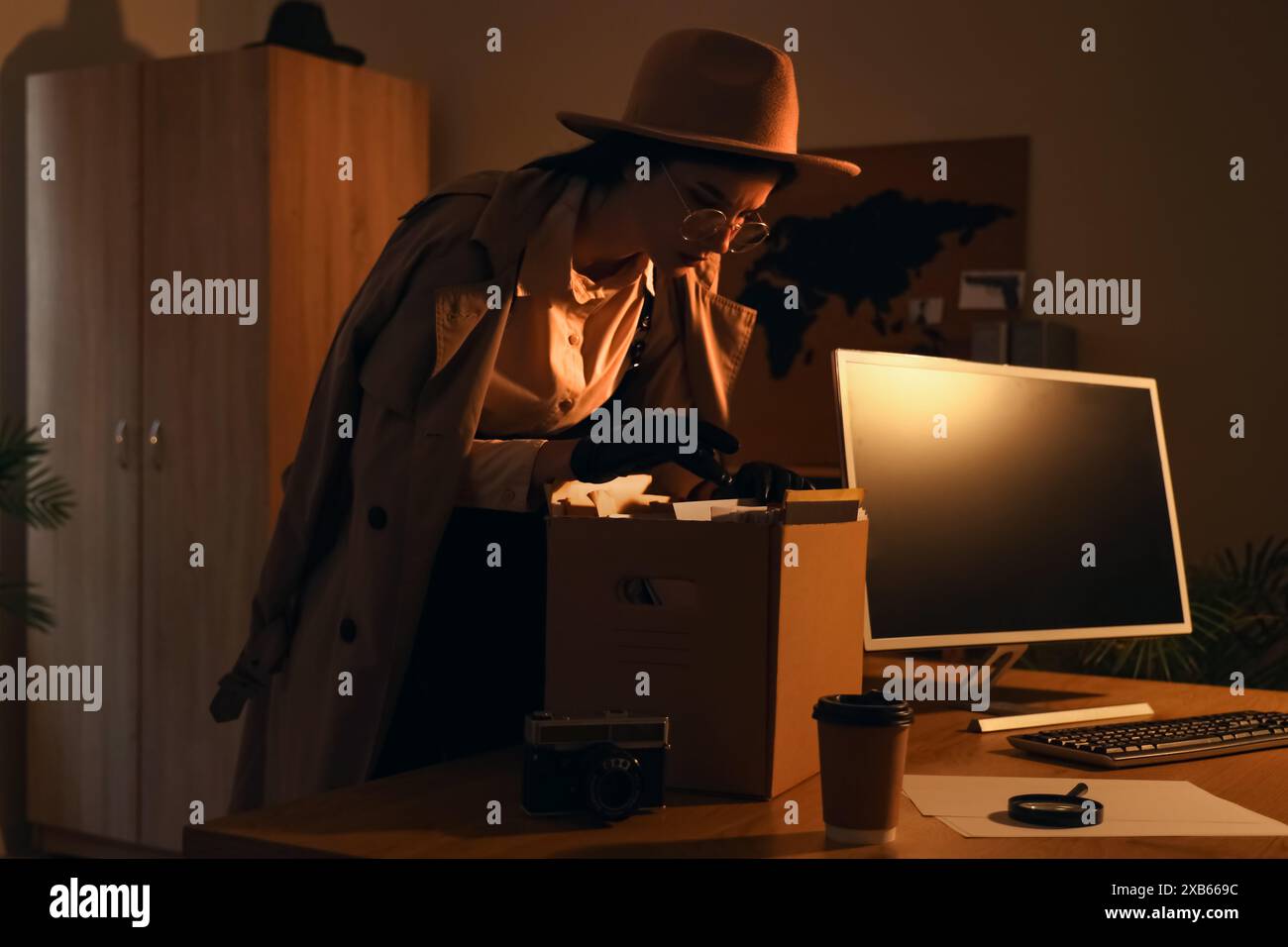 Female spy looking through files in office at night Stock Photo - Alamy