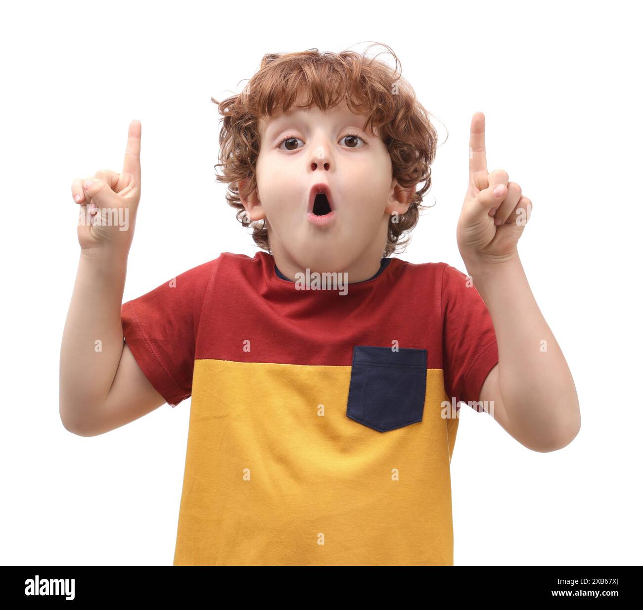 Portrait of emotional little boy pointing at something on white ...